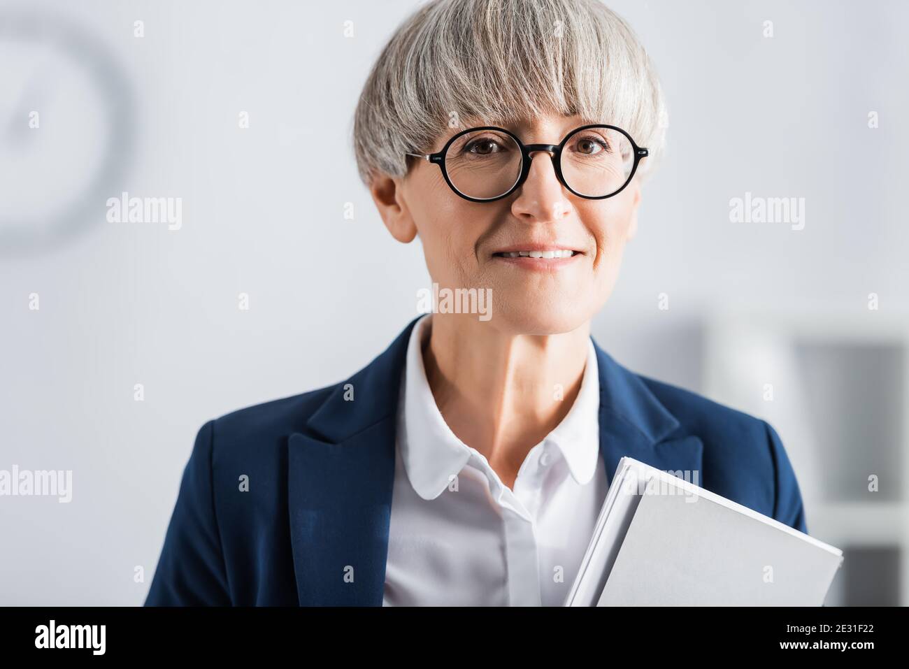 happy middle aged team leader in glasses and suit with folder Stock ...