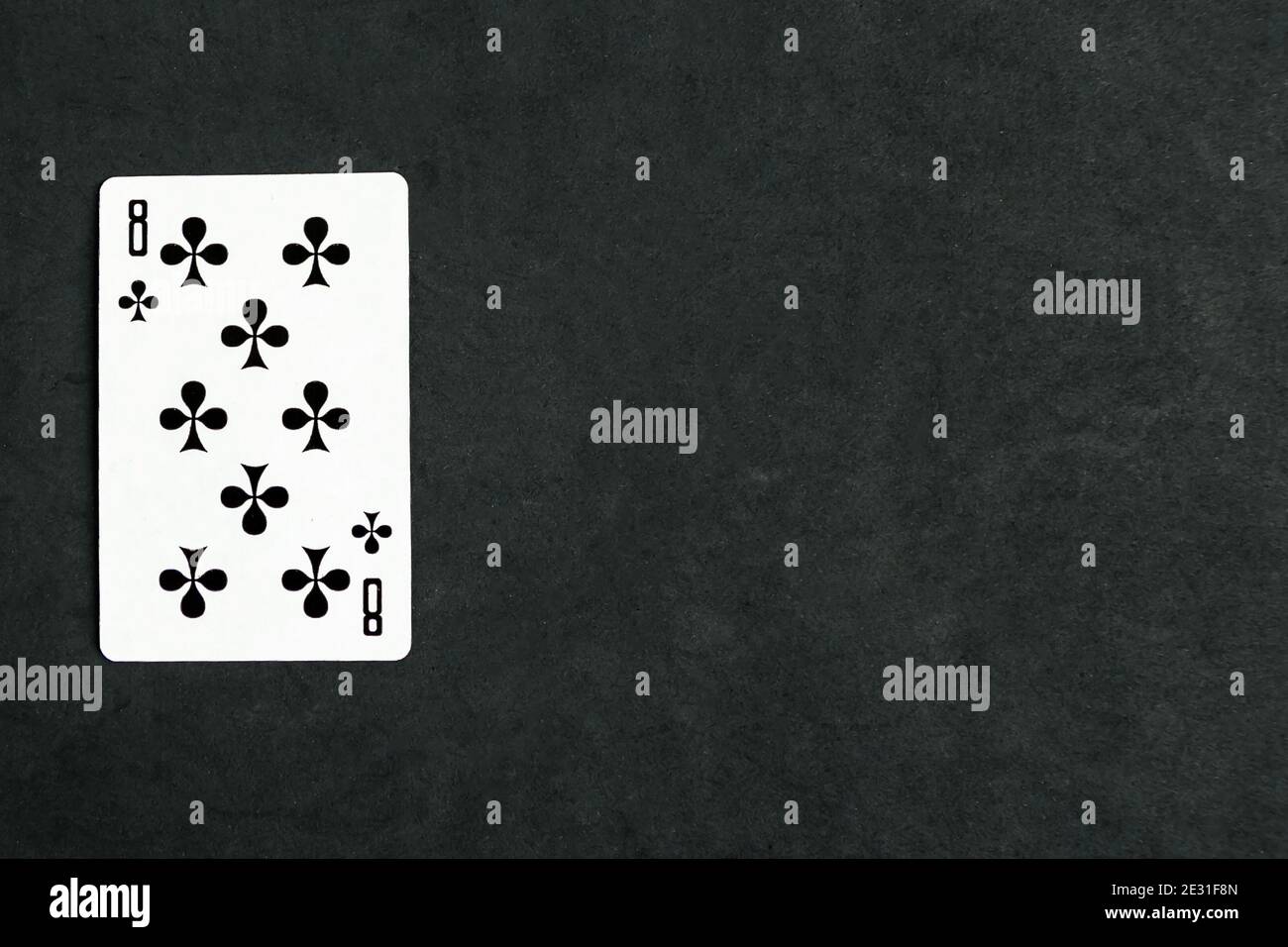 Eight of clubs isolated on white background Stock Photo - Alamy