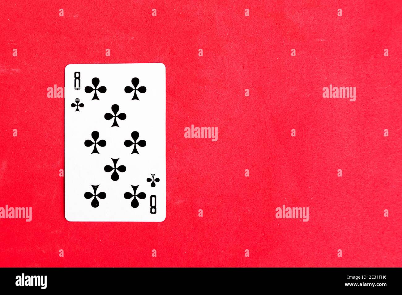 Eight of clubs isolated on white background Stock Photo - Alamy