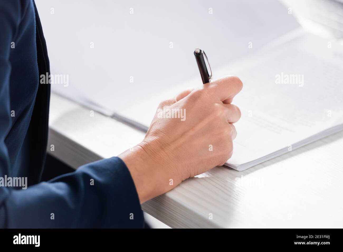 cropped view of team leader signing document on desk Stock Photo - Alamy
