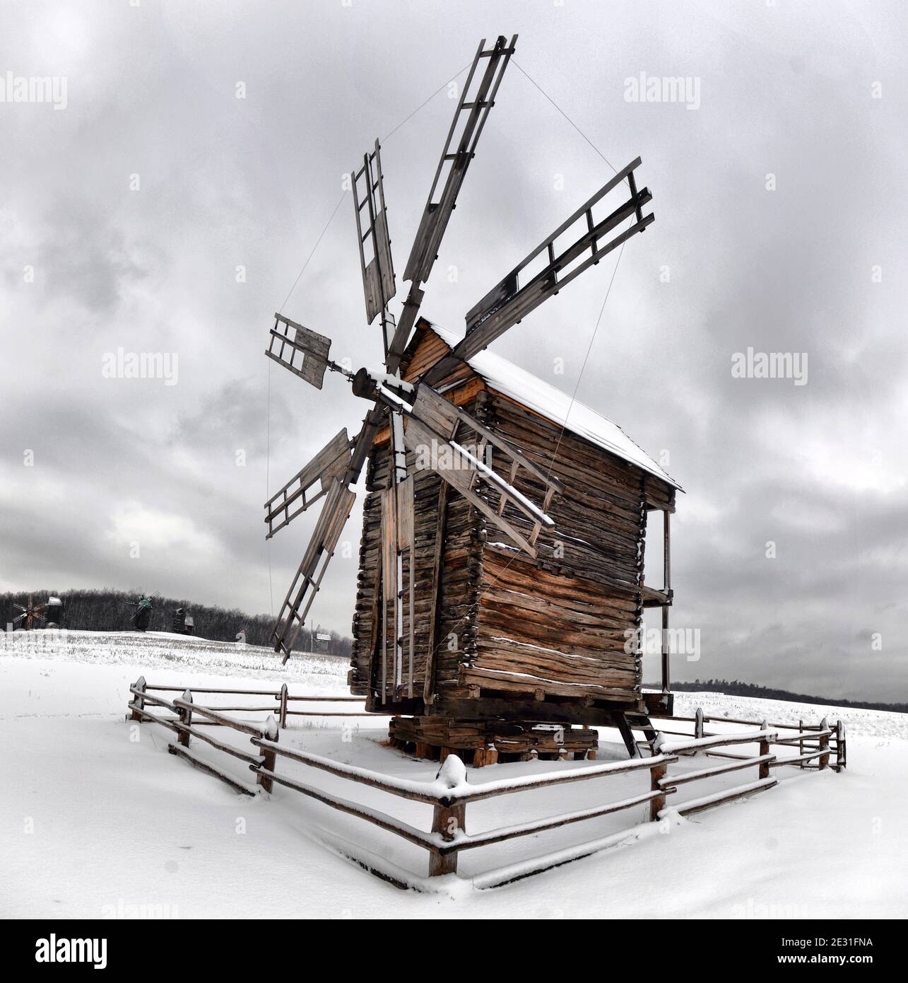 Antique wooden windmill in snowy ukrainian village. Winter landscape ...