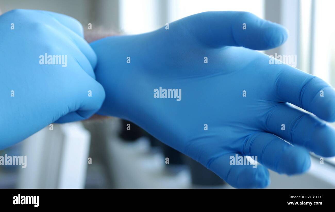 Hands wearing surgical rubber gloves hi-res stock photography and ...