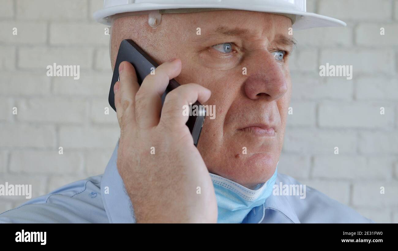 Engineer Wearing Helmet and Protective Medical Face Mask Talk to ...