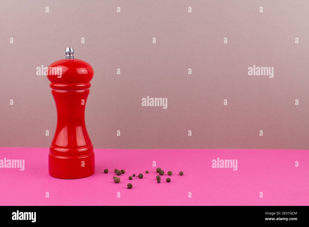 a red kitchen pepper shaker for ground pepper on the table Stock Photo ...