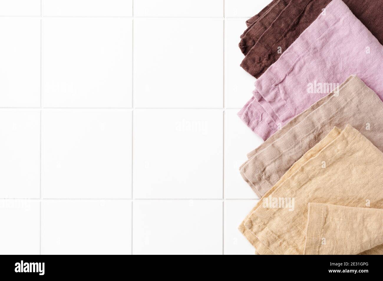 Four multi-colored napkins on cooking stone table with kitchen towel or ...