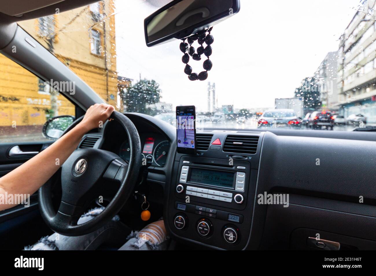 Using waze maps application on smartphone on car dashboard, Driver ...