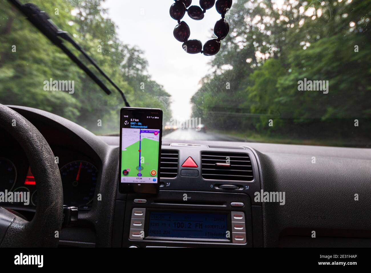 Using waze maps application on smartphone on car dashboard, Driver ...