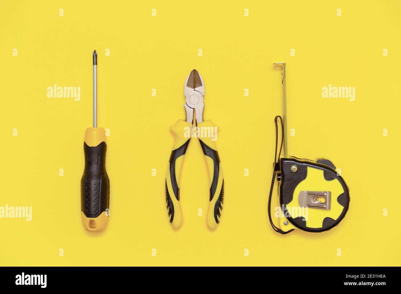 A flatlay with a set of bench tools, screwdriver, cutting pliers and ...