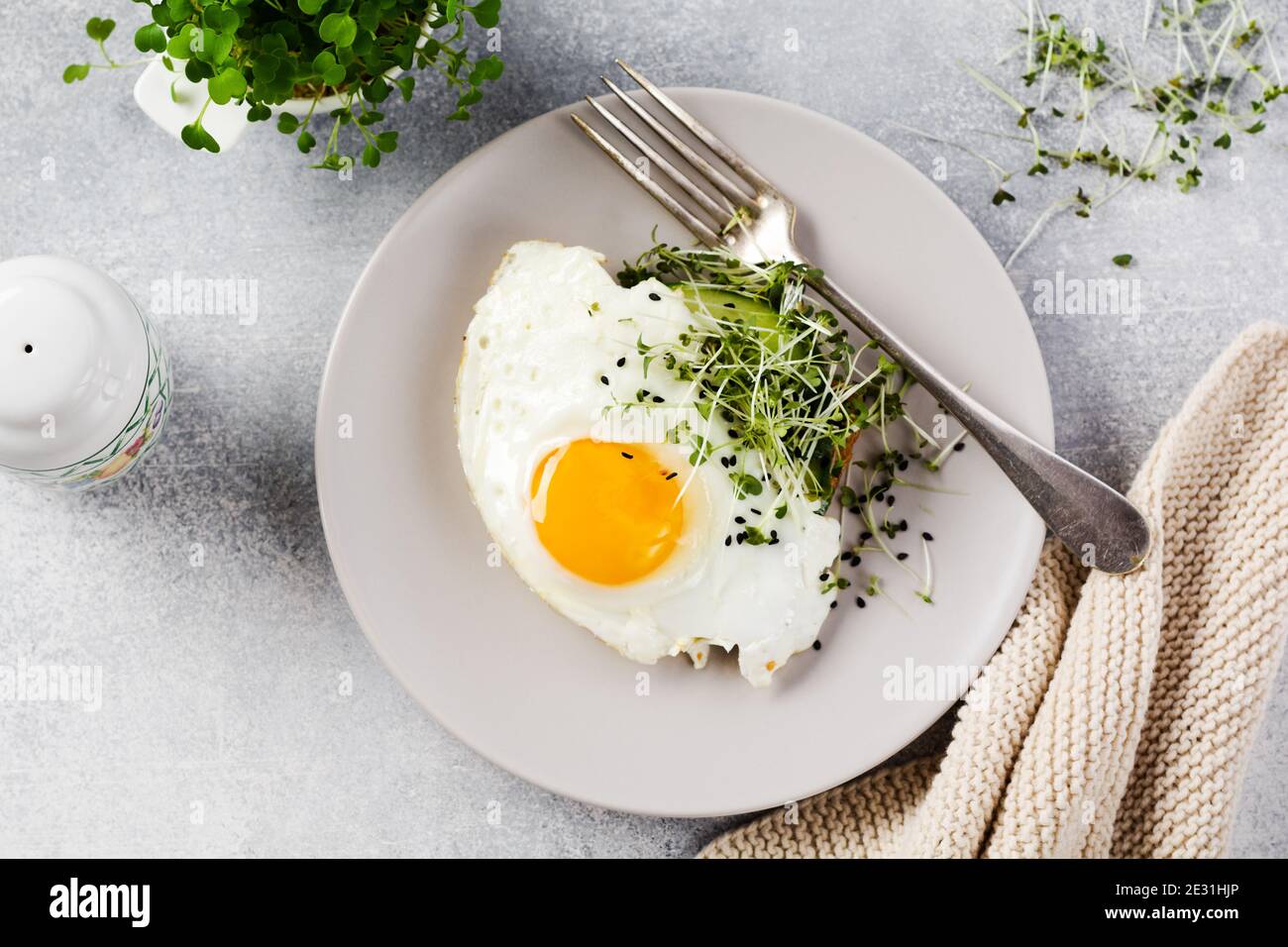 Traditional English breakfast with fried eggs with arugula microgreen ...