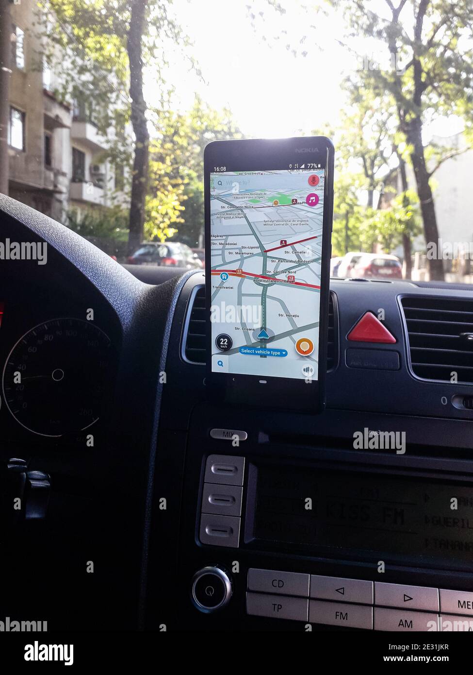 In car dashboard view with smartphone showing Waze maps to show the way ...
