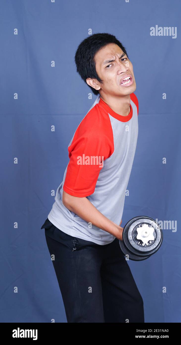 Asian man raises the barbell and back pain Stock Photo - Alamy