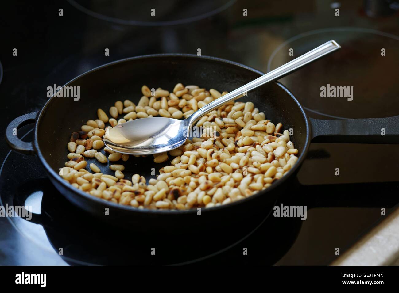 Roasted pine nuts in a cast iron skillet Stock Photo - Alamy