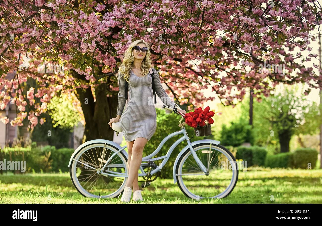 Spring time. girl flower seller with retro bike. vintage bicycle for ...
