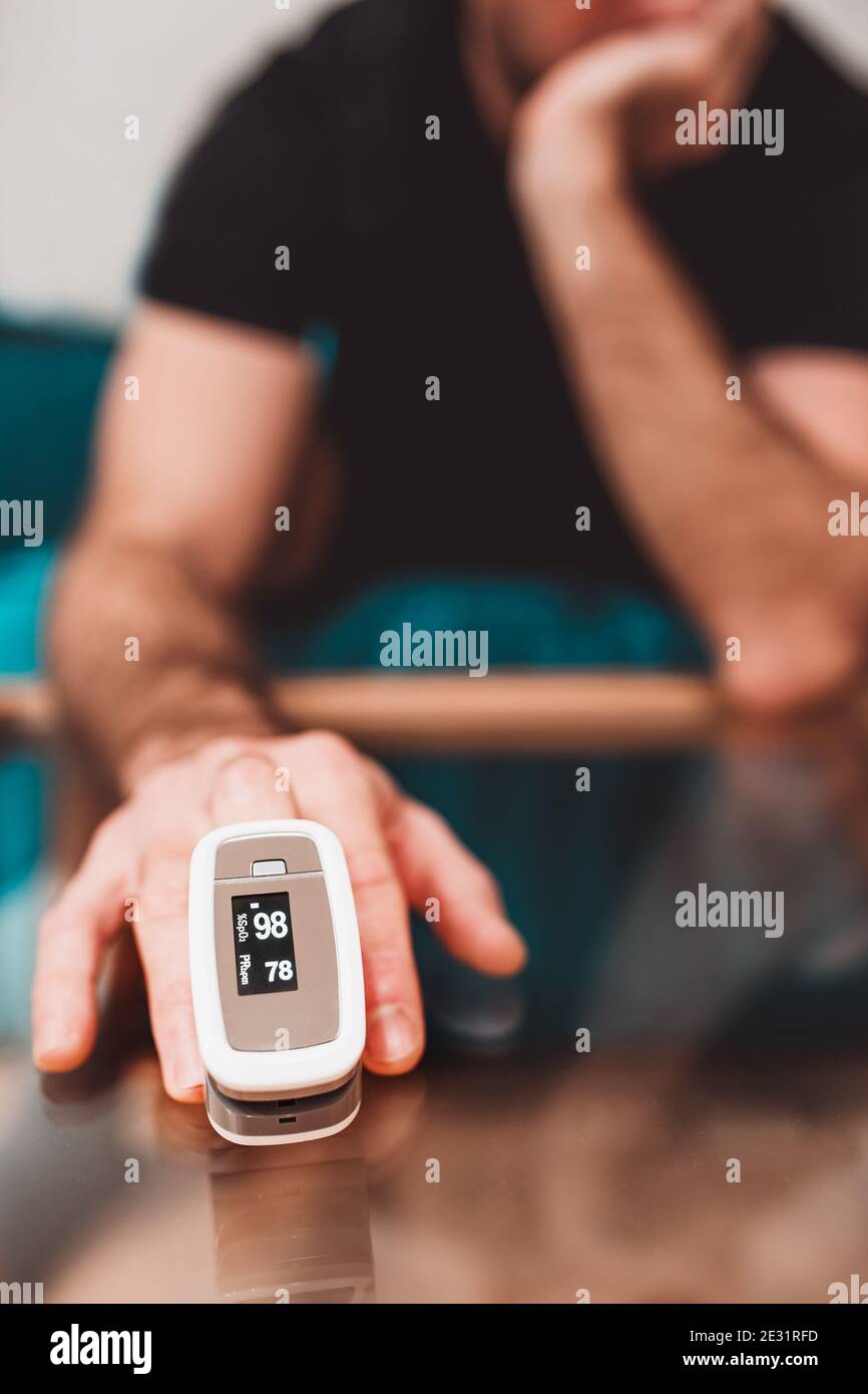 Self-diagnosis at home - Caucasian male finger pulse oximeter - self ...
