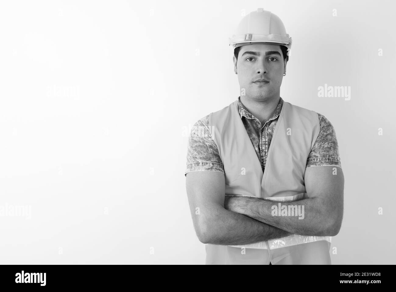 Young handsome Persian man construction worker against white background ...