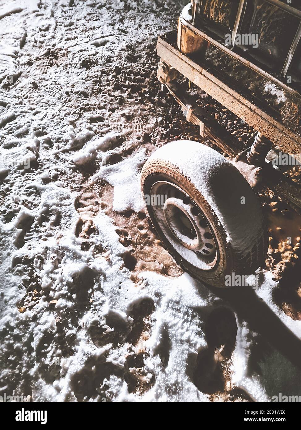 wagon wheel covered by snow with more snow on the ground trodden Stock ...