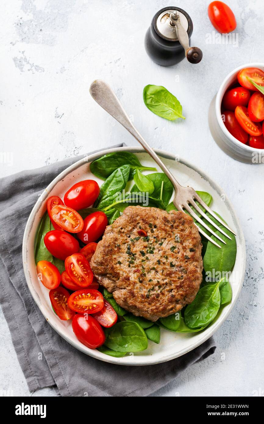 Grilled steak of beef with cherry tomatoes and spinach, garlic ...