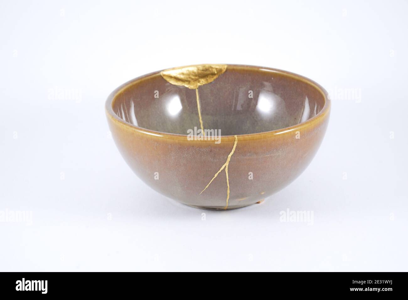 Japanese Kintsugi brown bowl restored with gold Stock Photo - Alamy