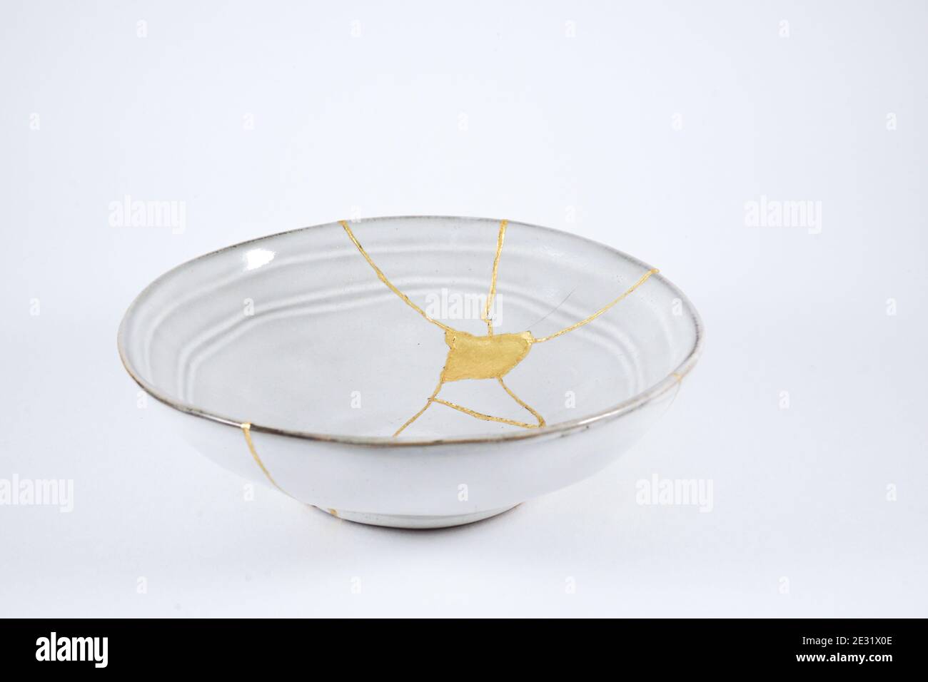 Kintsugi bowl, real gold restoration on grey pottery Stock Photo - Alamy