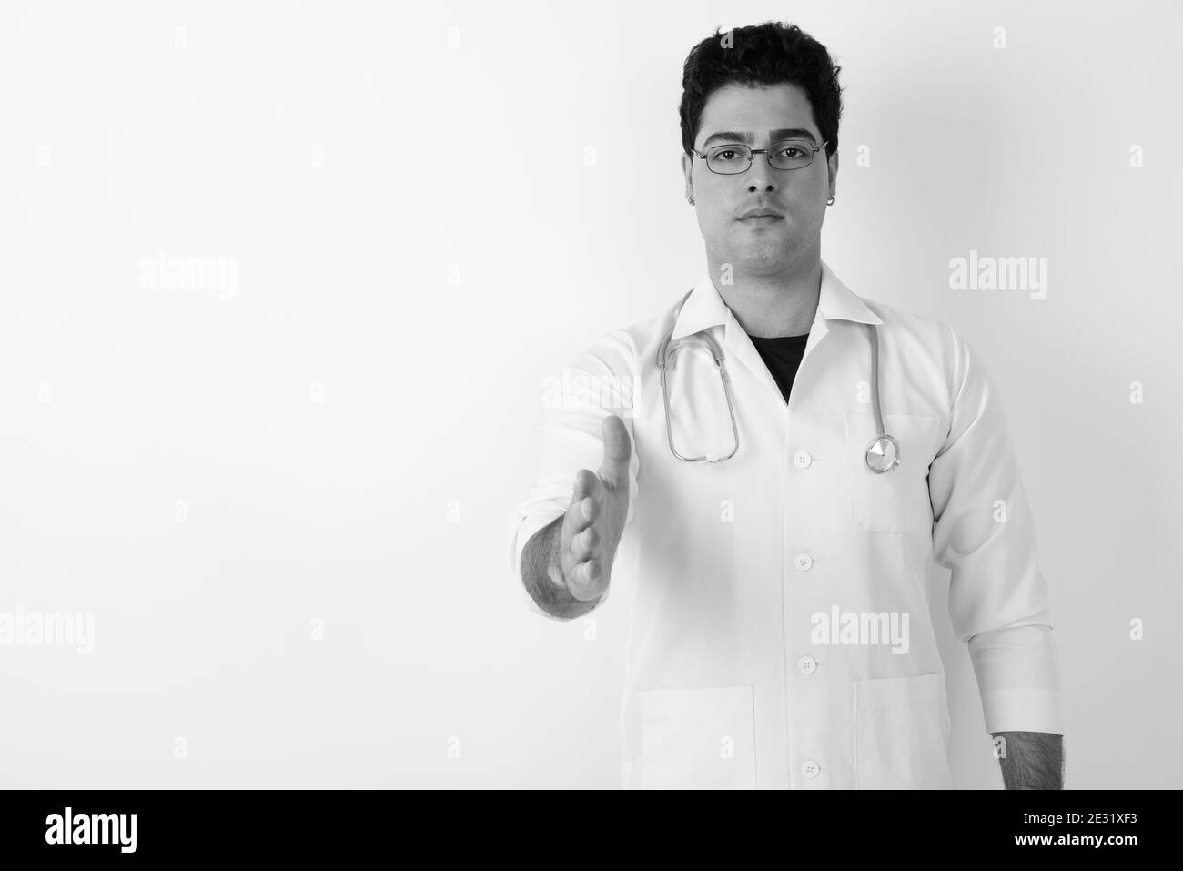 Young handsome Persian man doctor wearing eyeglasses against white ...