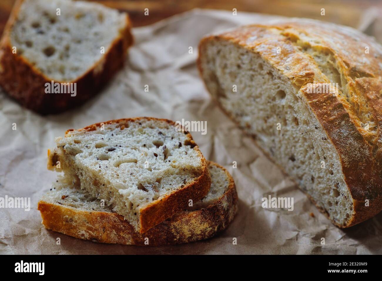 Homemade bread with cereals lies on rough craft paper. Delicious and ...