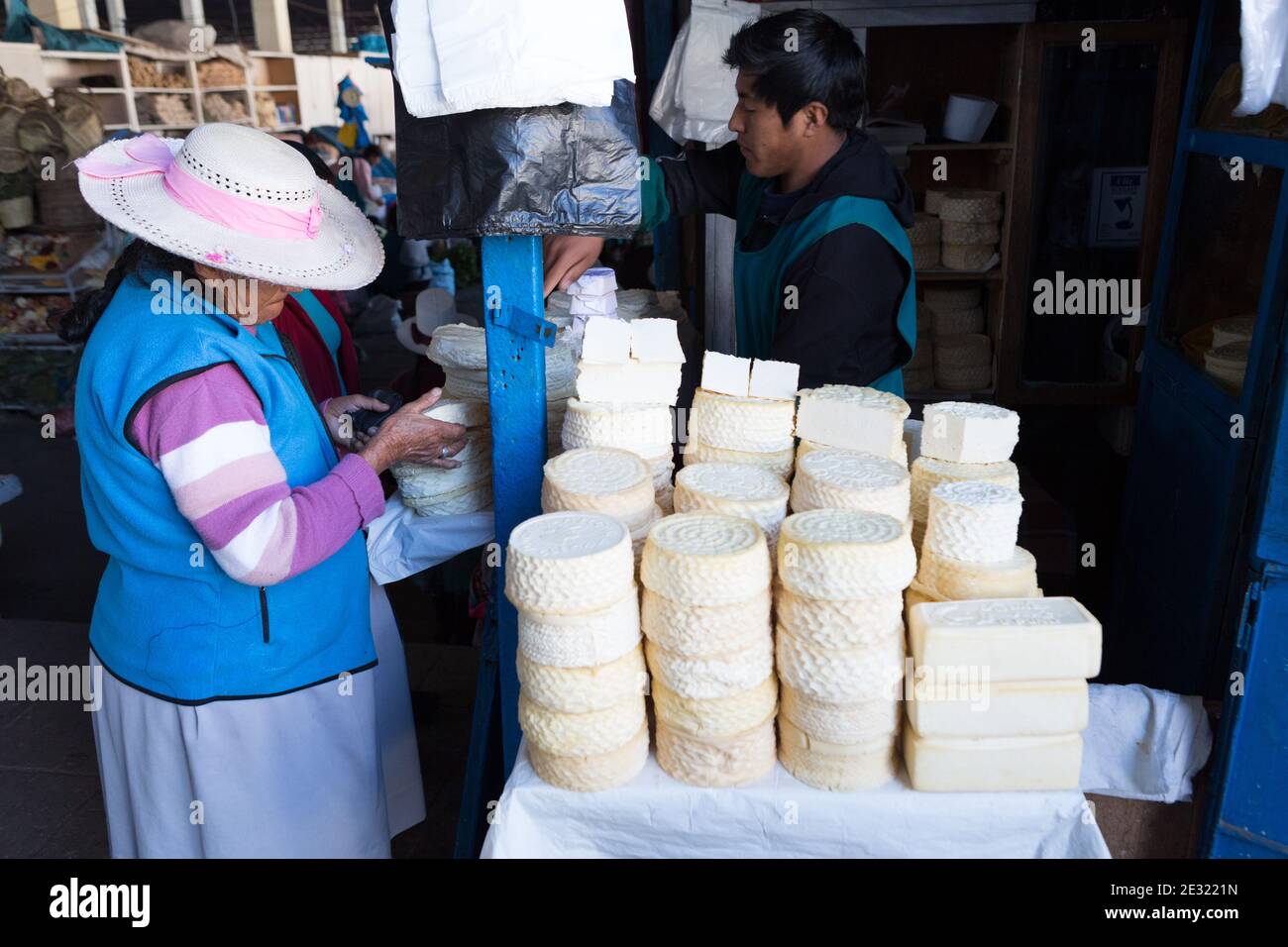 Woman buying wheels of cheese at the San Pedro Market Stock Photo - Alamy