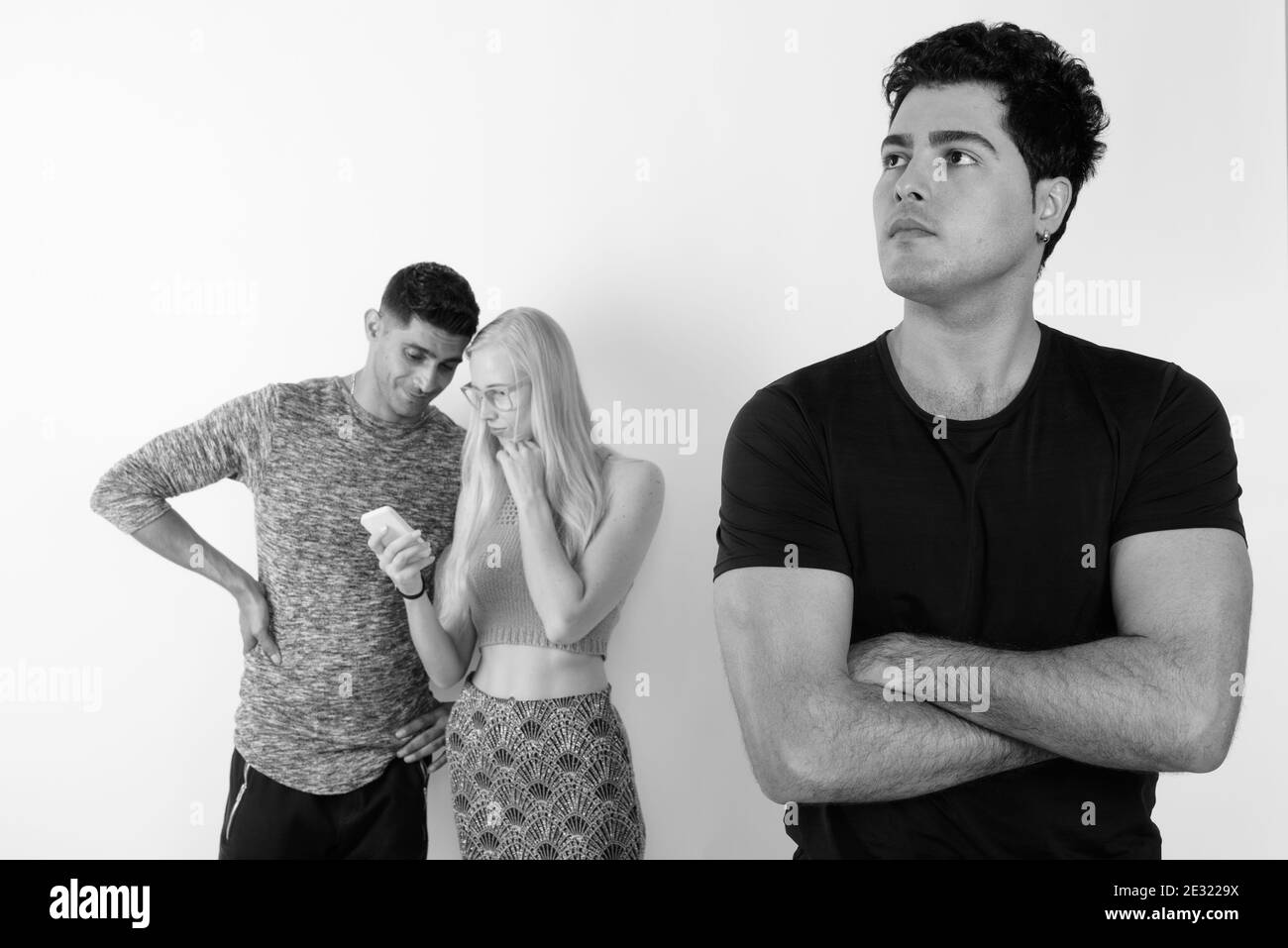 Three multi-ethnic friends together against white background Stock ...