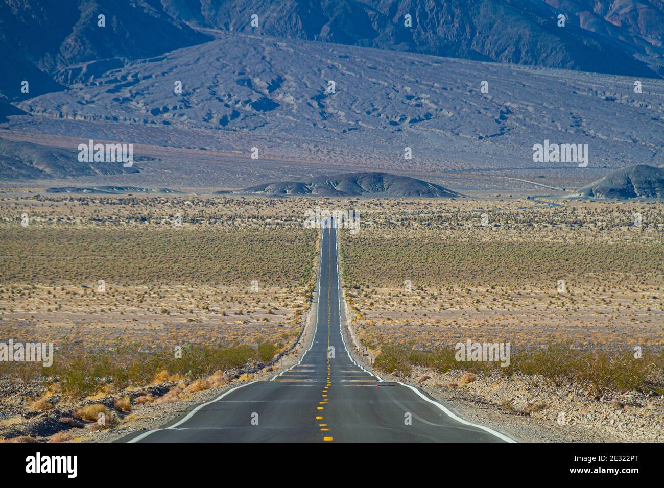 An empty road running straight through Death Valley National Park Stock ...