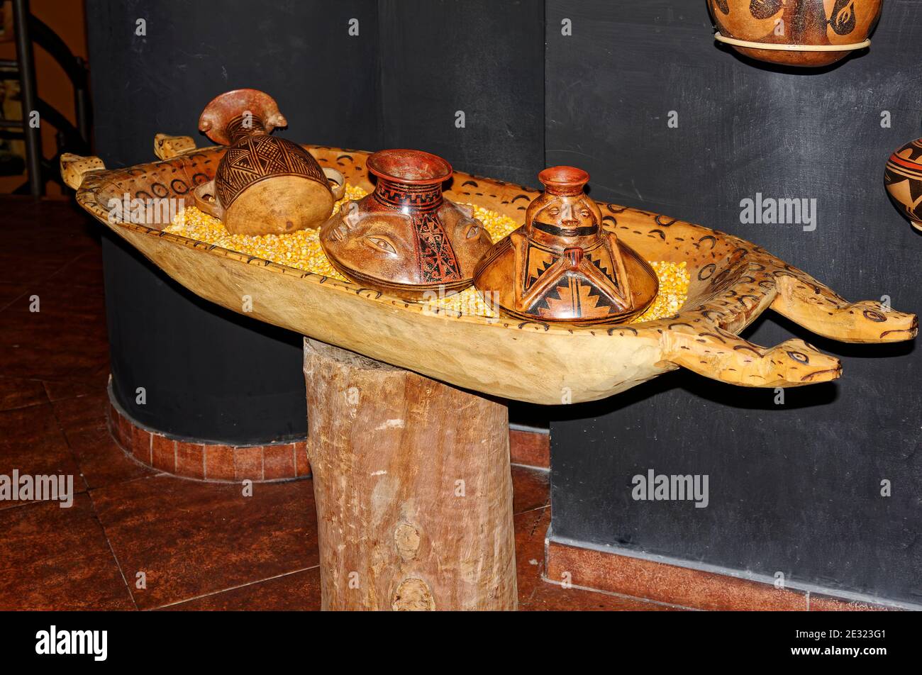 pottery display; Ethnic, carved wood bowl, corn, black background ...