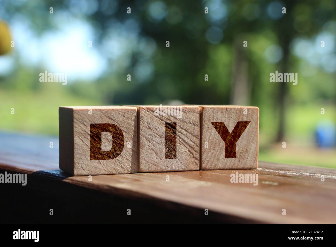 Wood cube blocks with letters DIY on red background. business concept ...