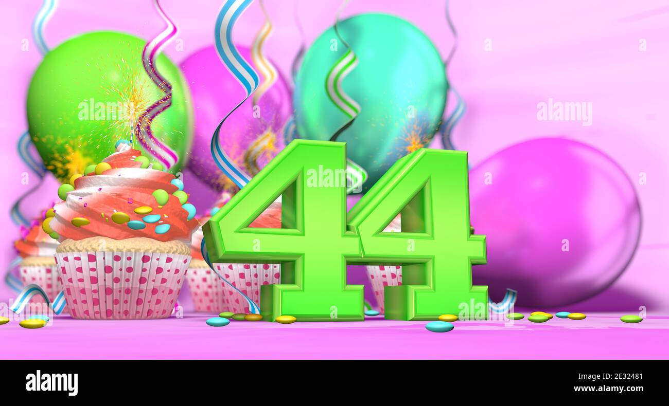 Birthday cupcake with sparking candle with the number 44 large in green ...