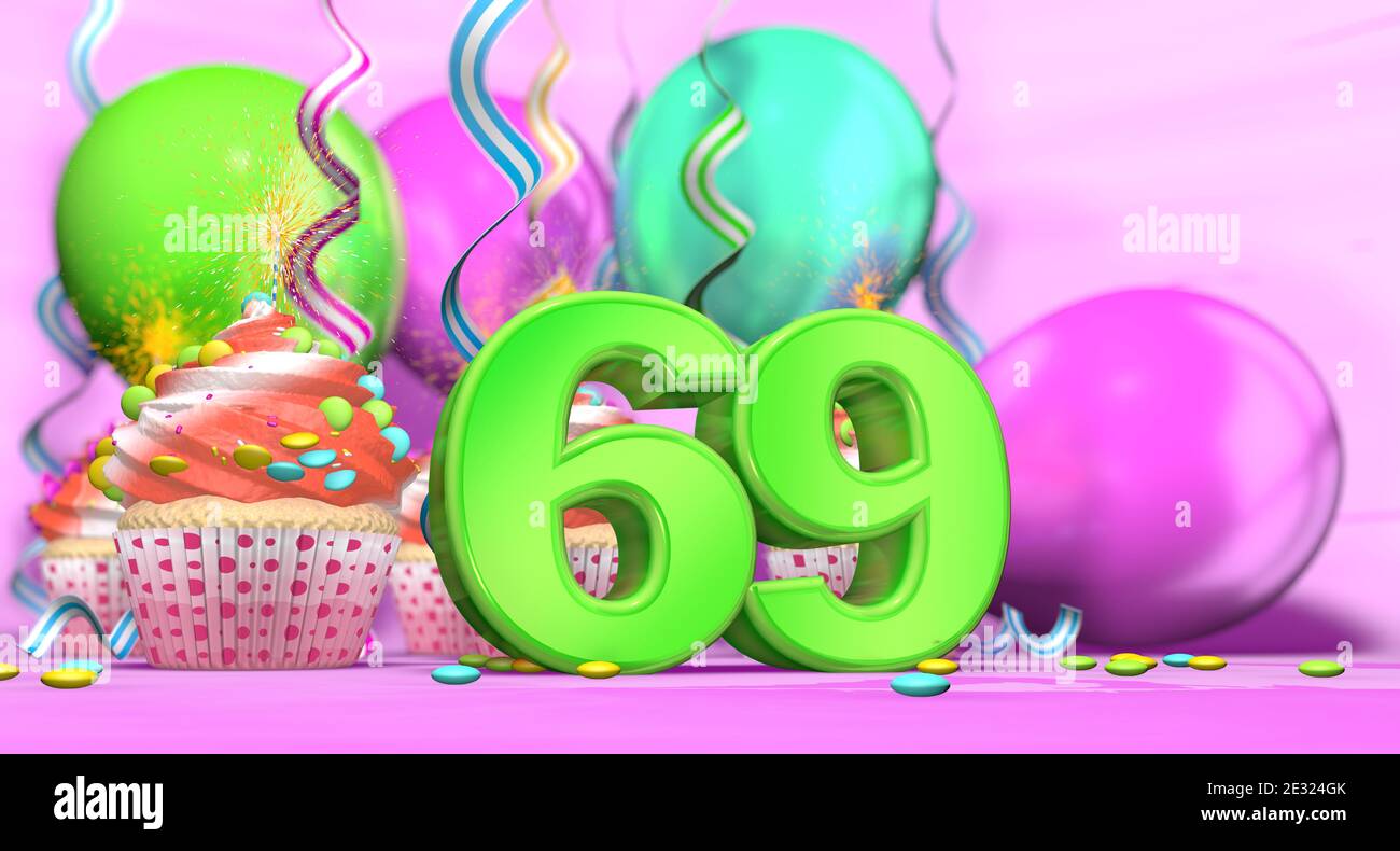 Birthday cupcake with sparking candle with the number 69 large in green ...