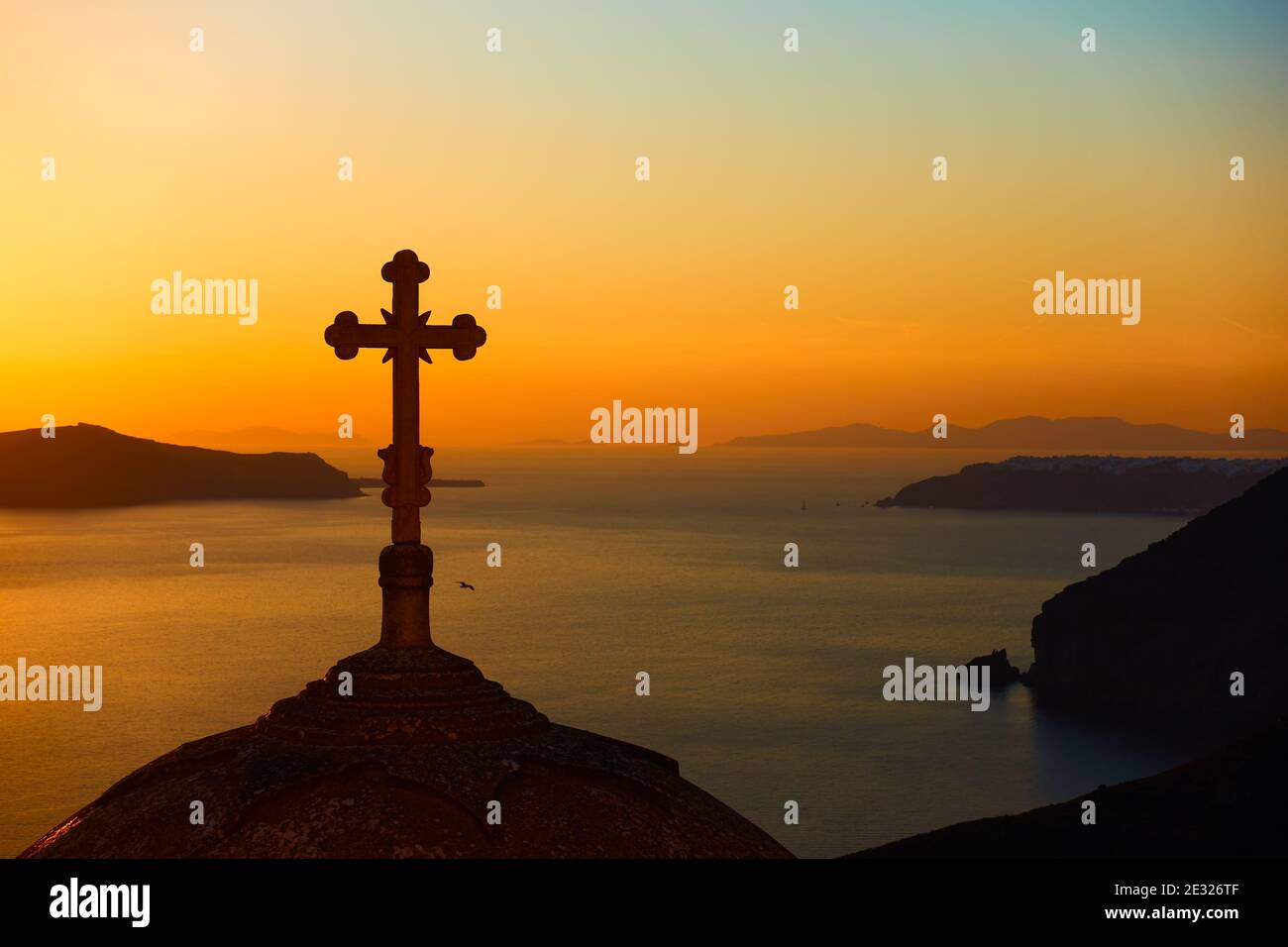 Silhouette of cupola with cross of Greek Orthodox Church and the sea in ...
