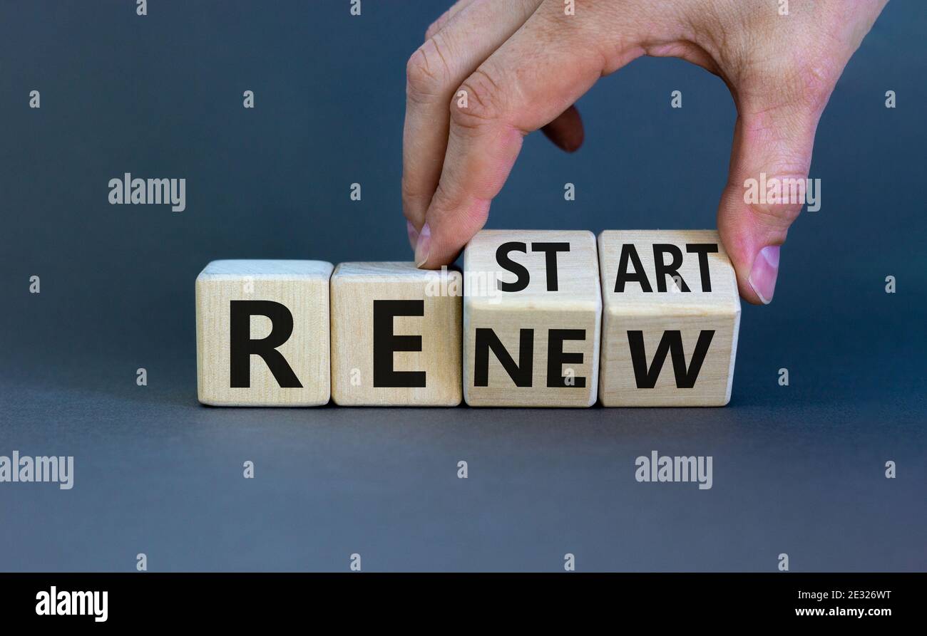 Renew and restart symbol. Businessman hand turns cubes and changes the ...