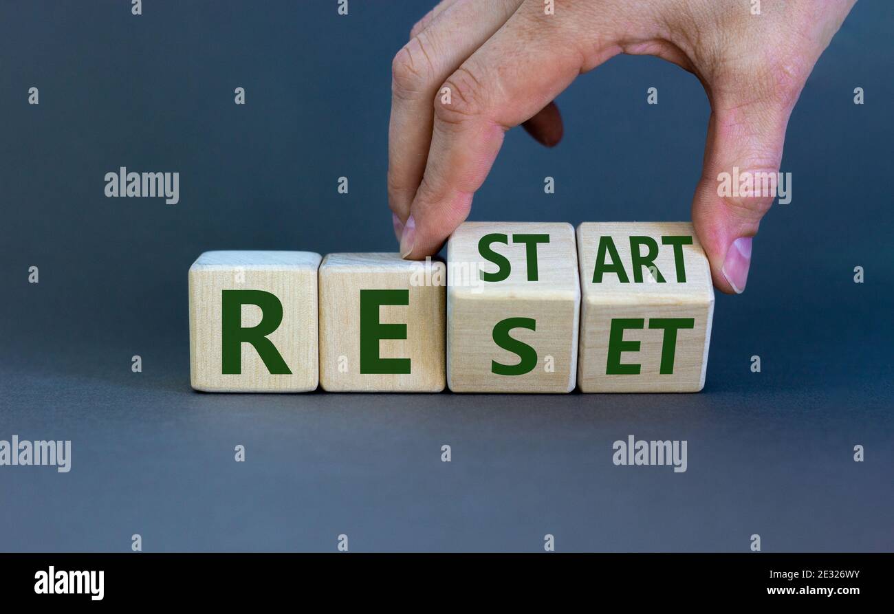 Reset and restart symbol. Businessman hand turns cubes and changes the ...