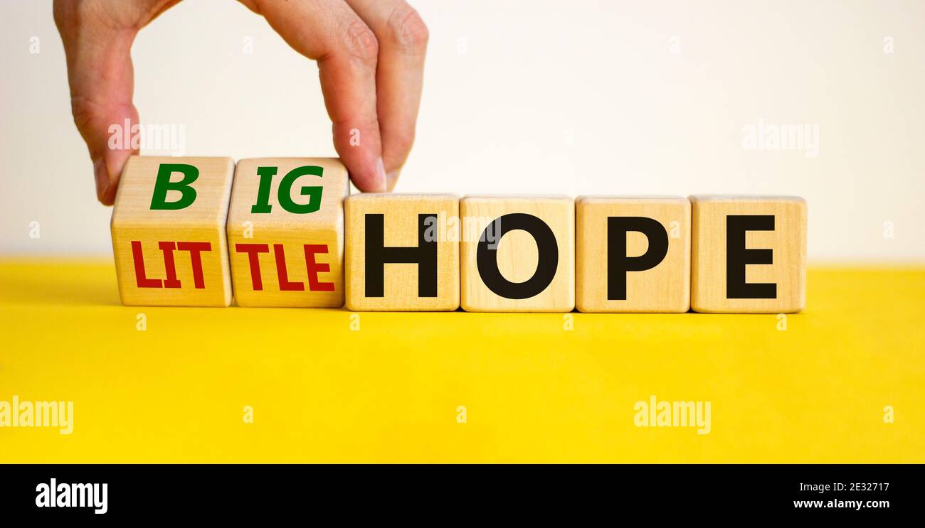 Little or big hope symbol. Hand turns wooden cubes and changes words ...