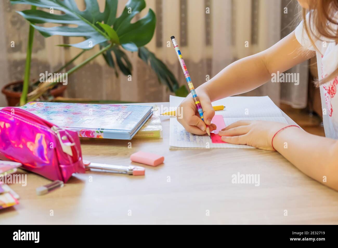 The child does his homework, drawing with a ruler. Selective focus ...