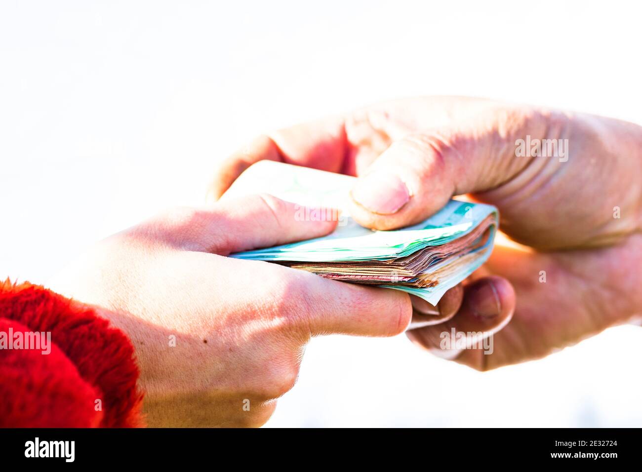 Hand giving stack of money isolated, hard worked hand taking euro money ...