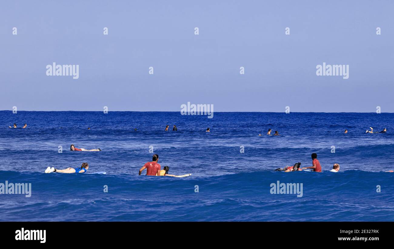 Surf school, students waiting for the first wave. Surfer on the wave ...