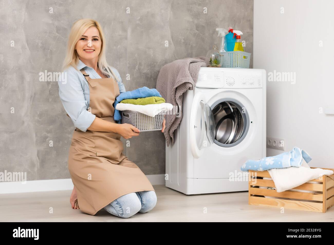 pretty smiling girl in the laundry room Stock Photo - Alamy