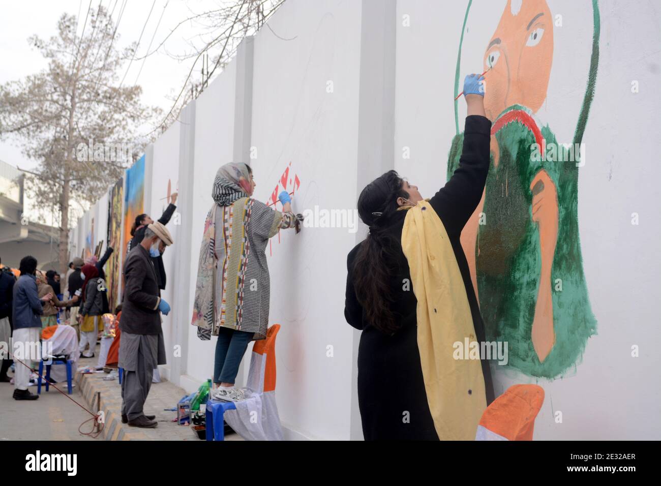 QUETTA, PAKISTAN. JAN 14 2021: Volunteer artist making art on wall ...