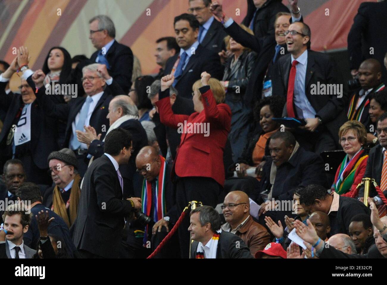 Germany's Angela Merkel is congratulated at the end of the game by Sepp ...