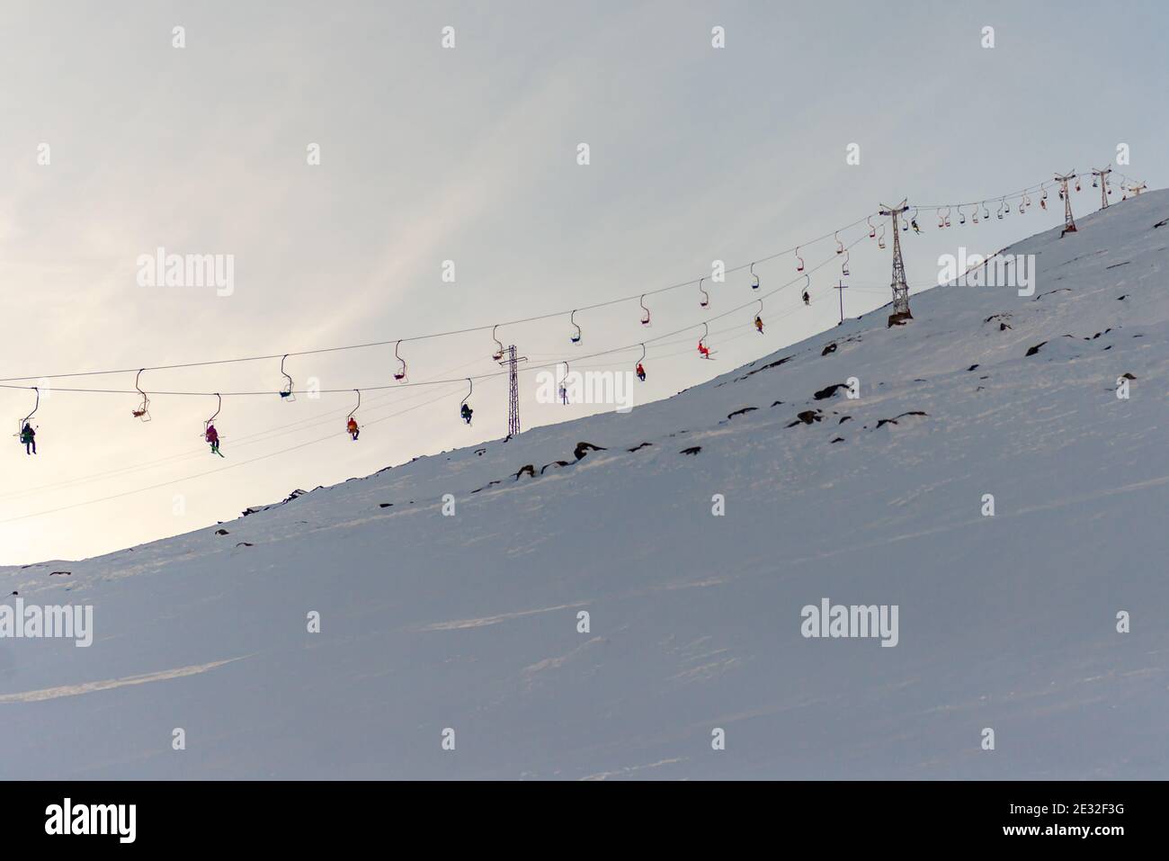 The old chair lift on mount Cheget. Skiers climb the mountain Stock ...