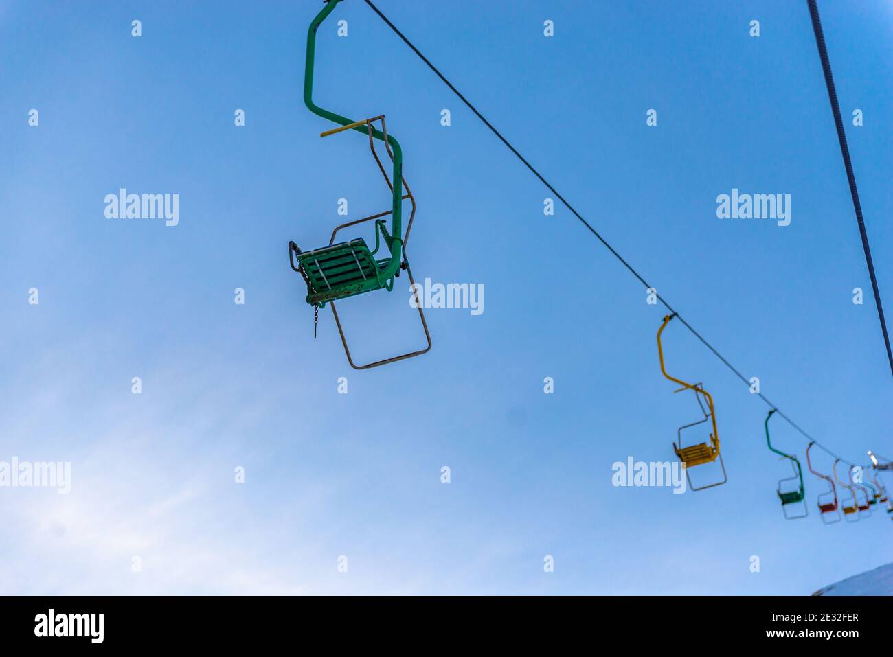 The old chair lift on mount Cheget. Multicolored chairlifts going up ...