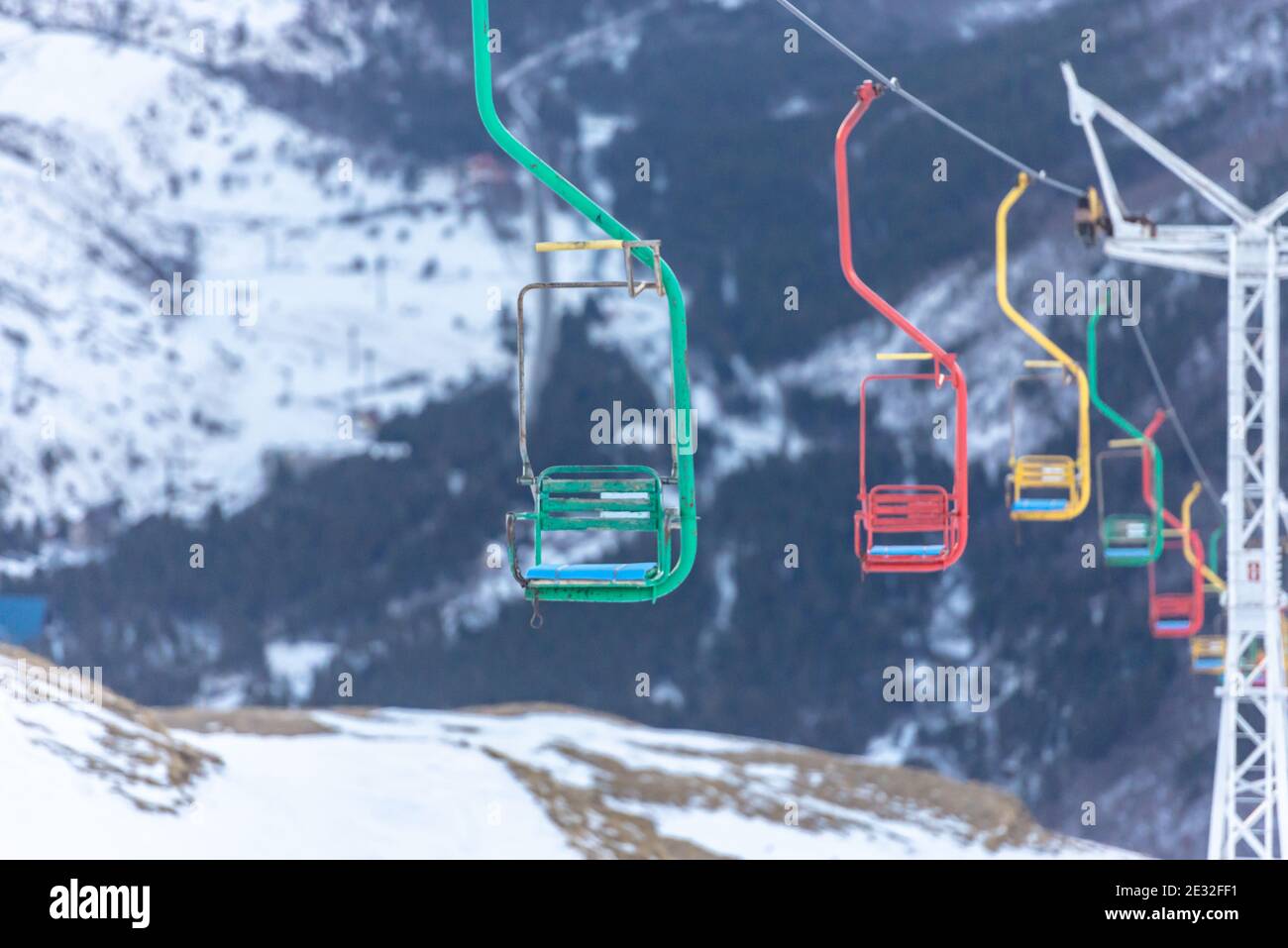 The old chair lift on mount Cheget. Single chair lift and mountain in ...