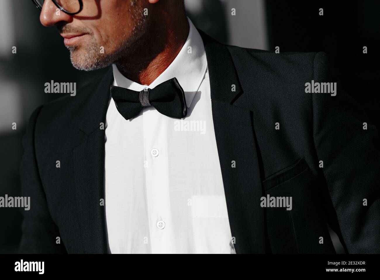 Black suit with white shirt and black bow tie hi-res stock photography ...