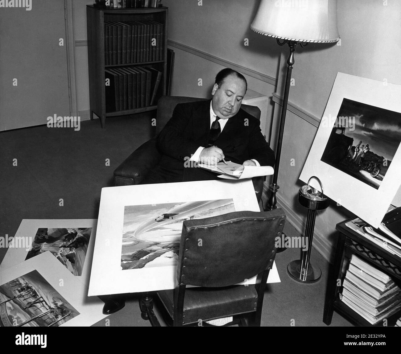 Director ALFRED HITCHCOCK in his Office at Universal Studios surrounded ...