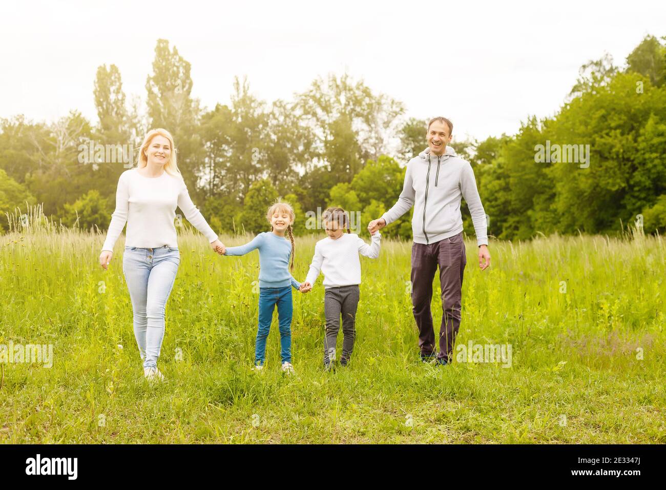 Happy family enjoying life together at meadow outdoor Stock Photo - Alamy