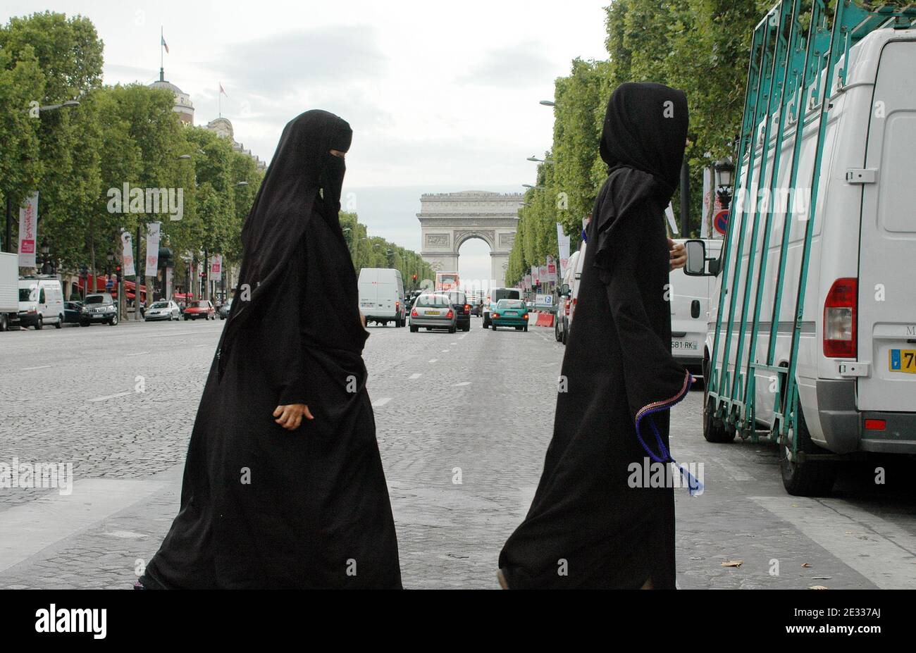 Muslim women with black traditional chador on Champs Elysees avenue in ...