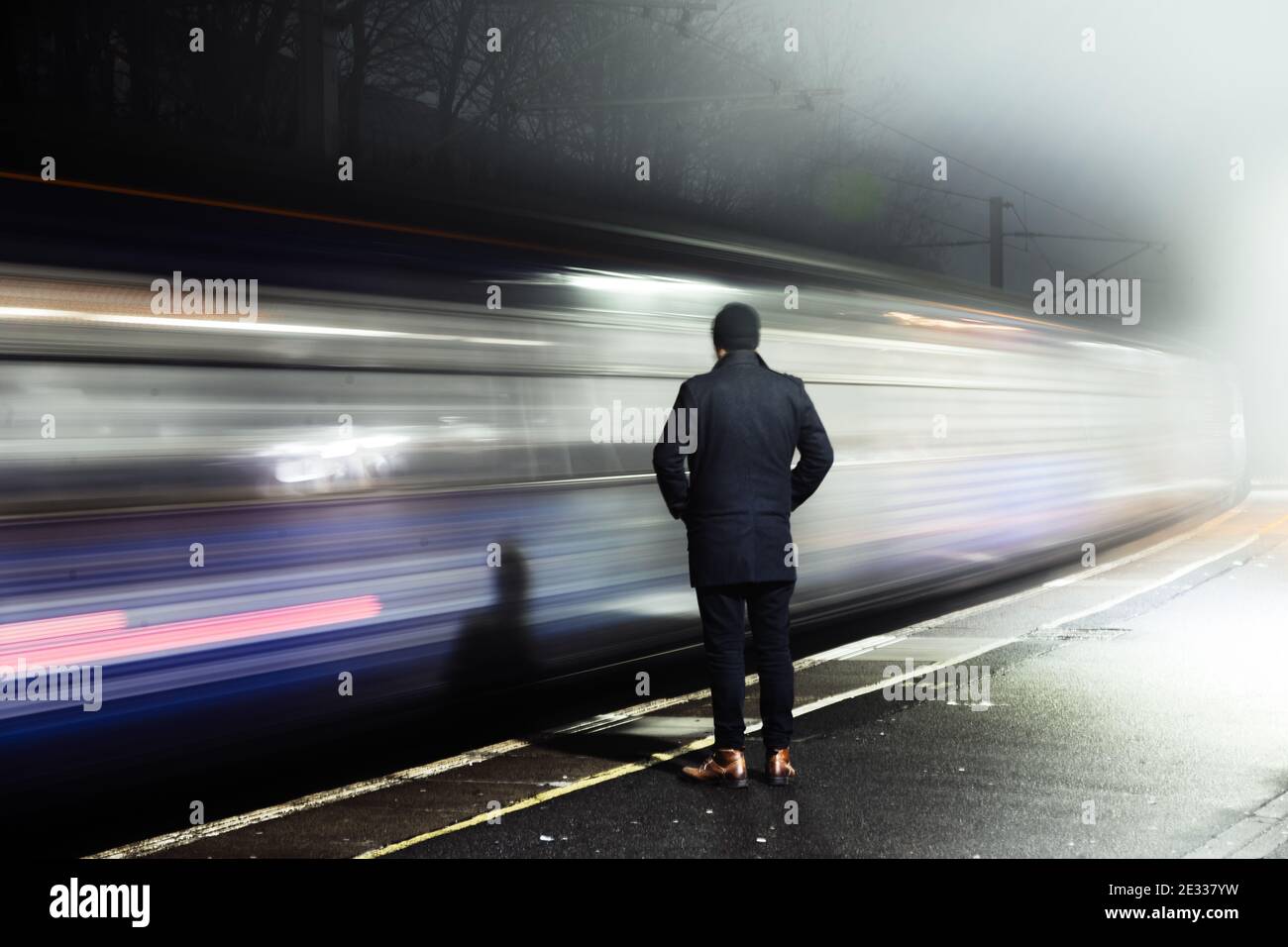 man standing on a platform Stock Photo - Alamy